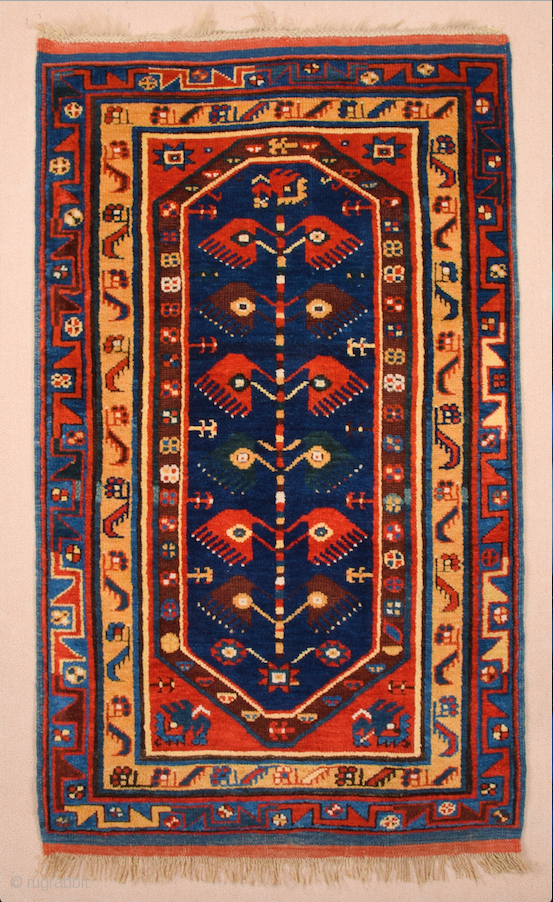 The golden yellow field of this classic Megri is divided into one ...