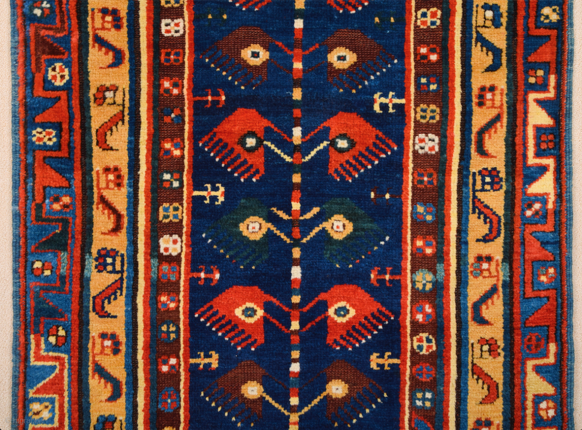 The golden yellow field of this classic Megri is divided into one ...